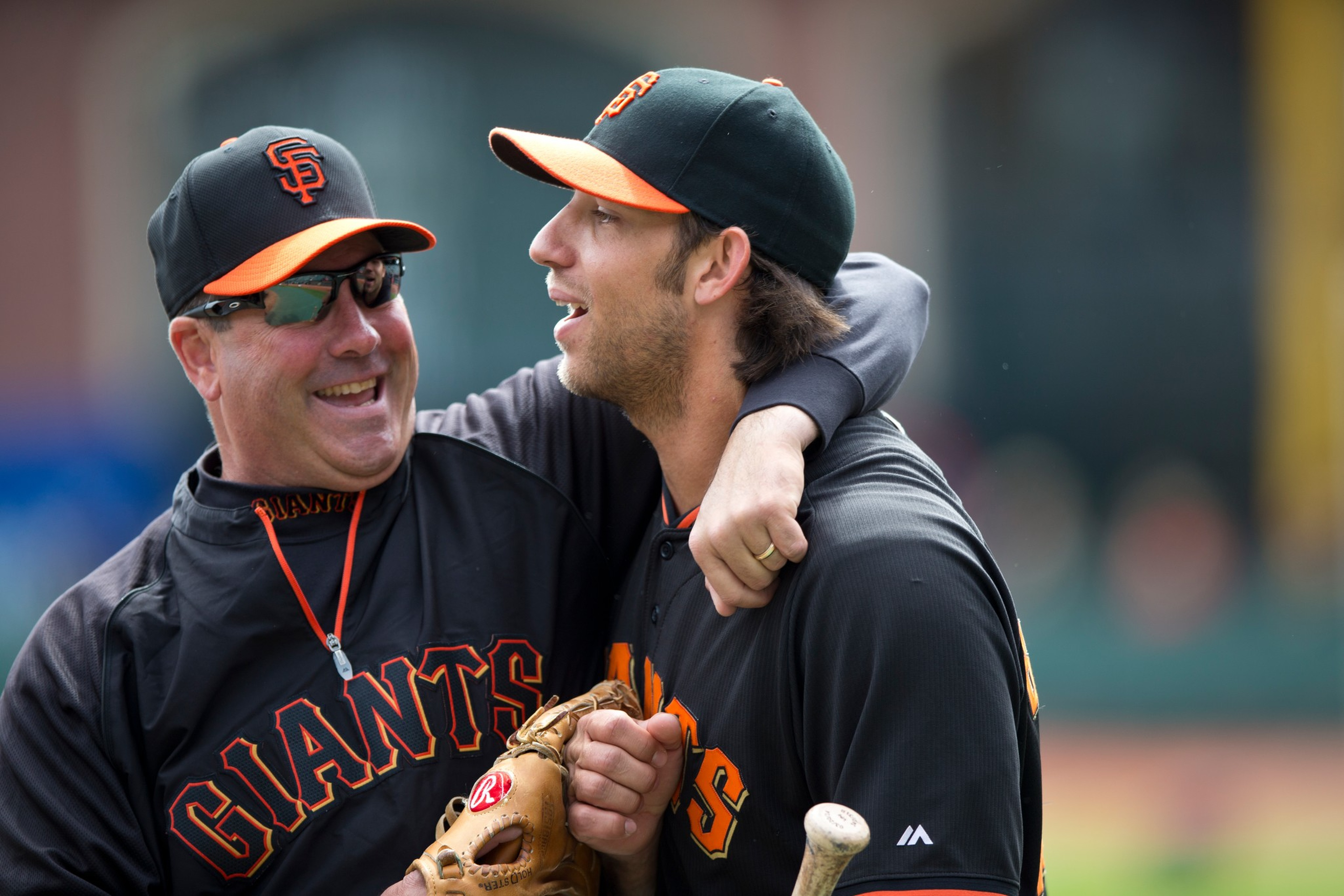 Two San Francisco Giants baseball players smile and embrace, wearing ...