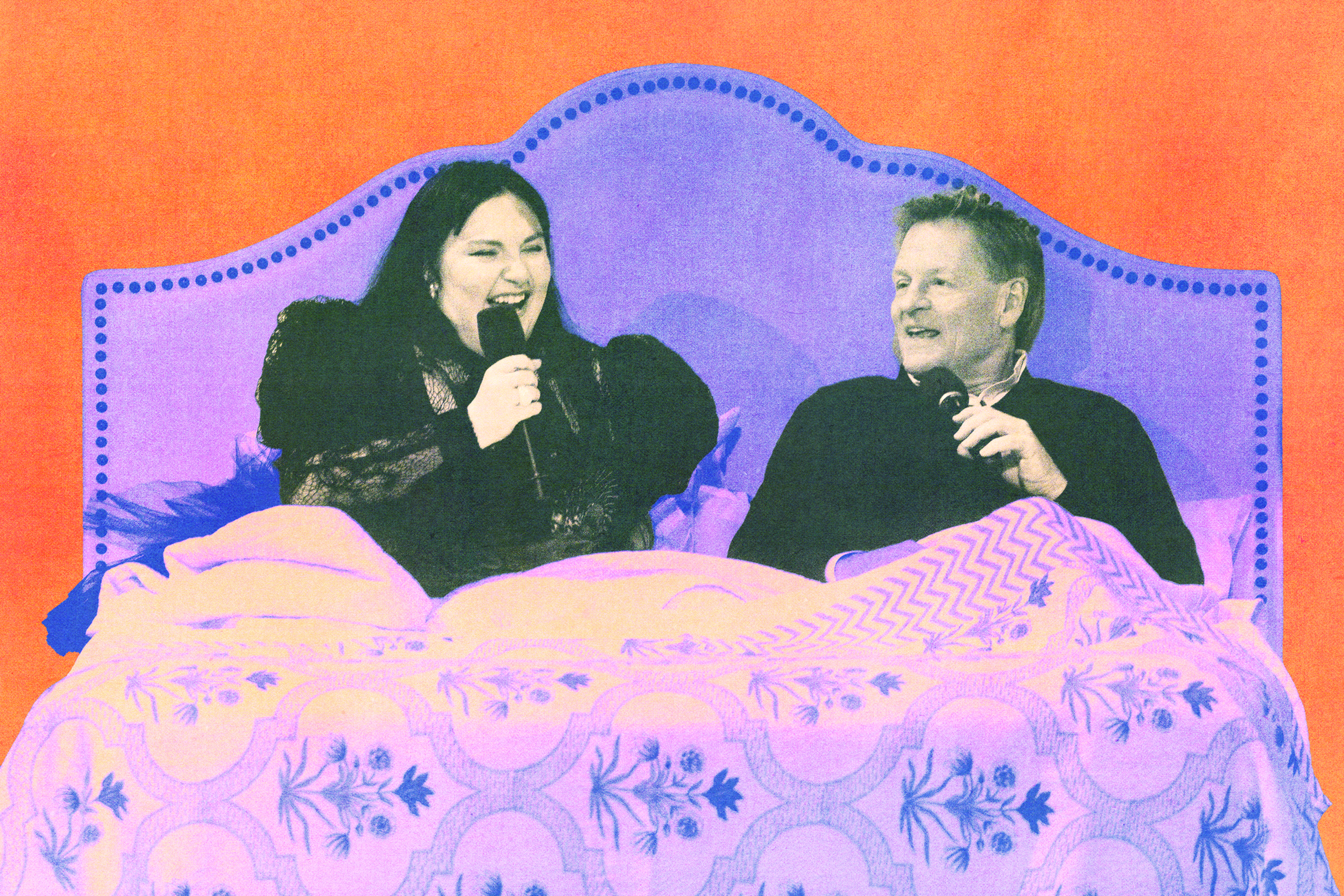 A woman and a man sit side by side in a bed with microphones, laughing ...