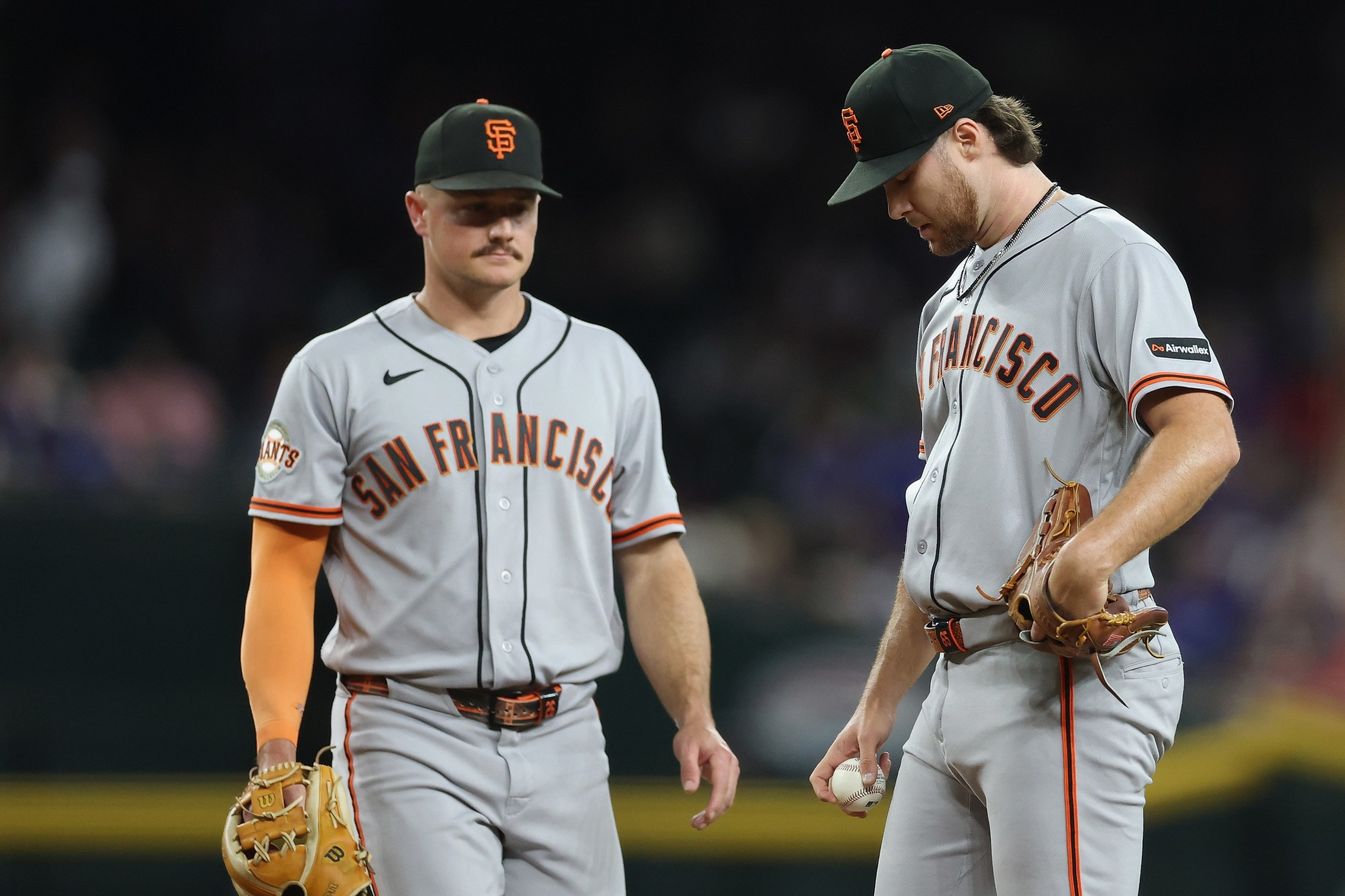 Two San Francisco Giants baseball players stand on the field, both ...